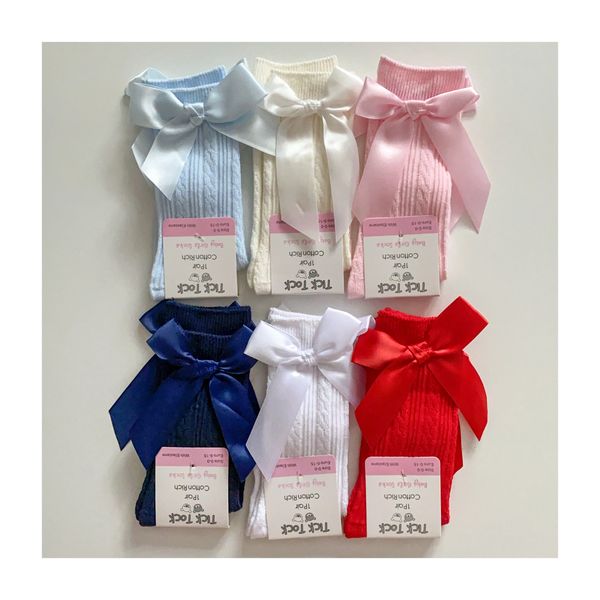 Cable pattern knee socks with ribbon bow