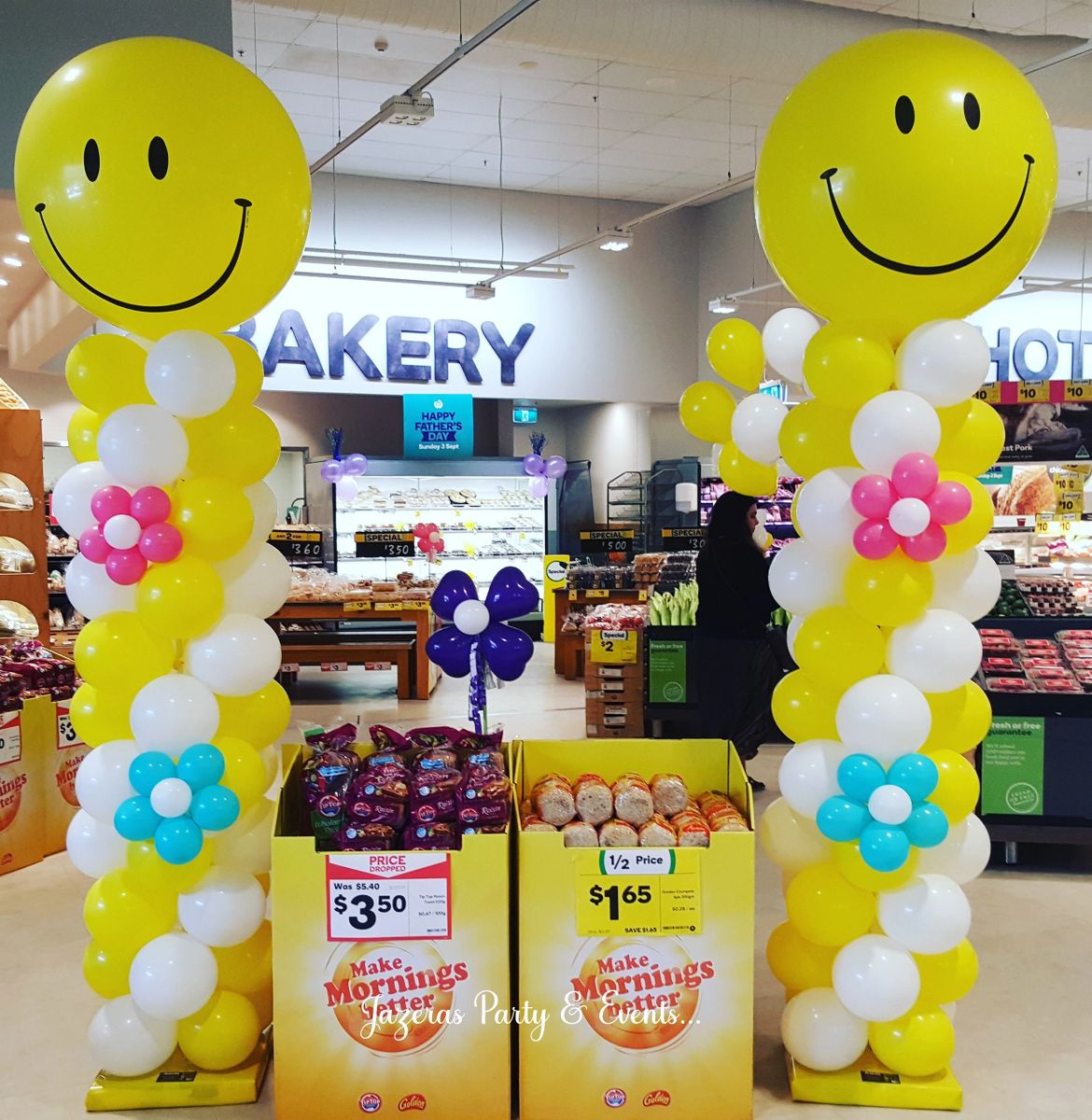 Smiley Face Jumbo Balloon Columns with flowers - Woolworths